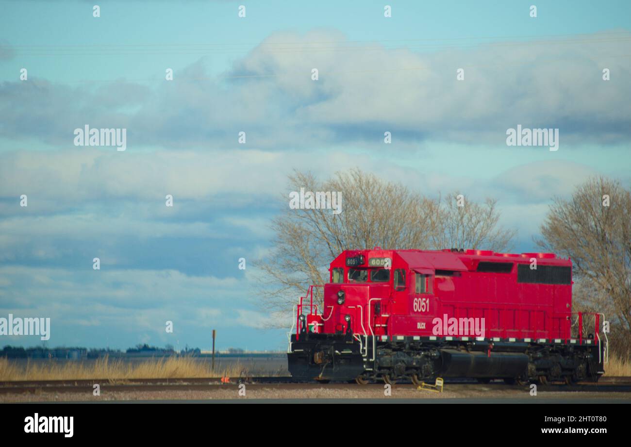 Red train getting ready to be loaded under the cloudy skies Stock Photo ...