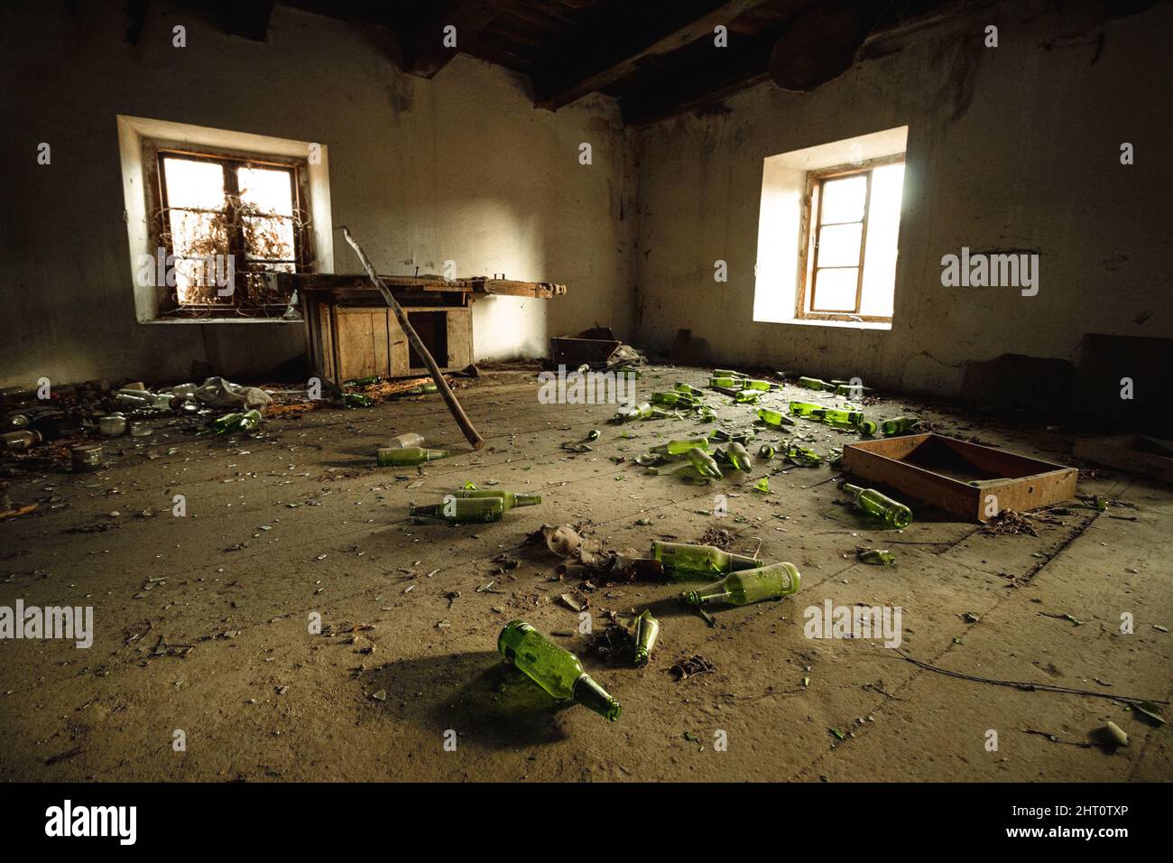 Old abandoned dirty room with a lot of garbage, mostly beer bottles ...