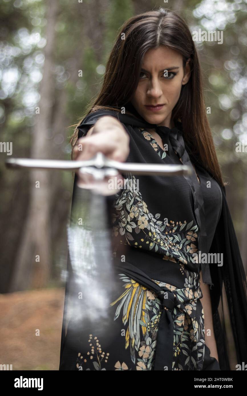 Portrait young woman sword forest hi-res stock photography and images ...