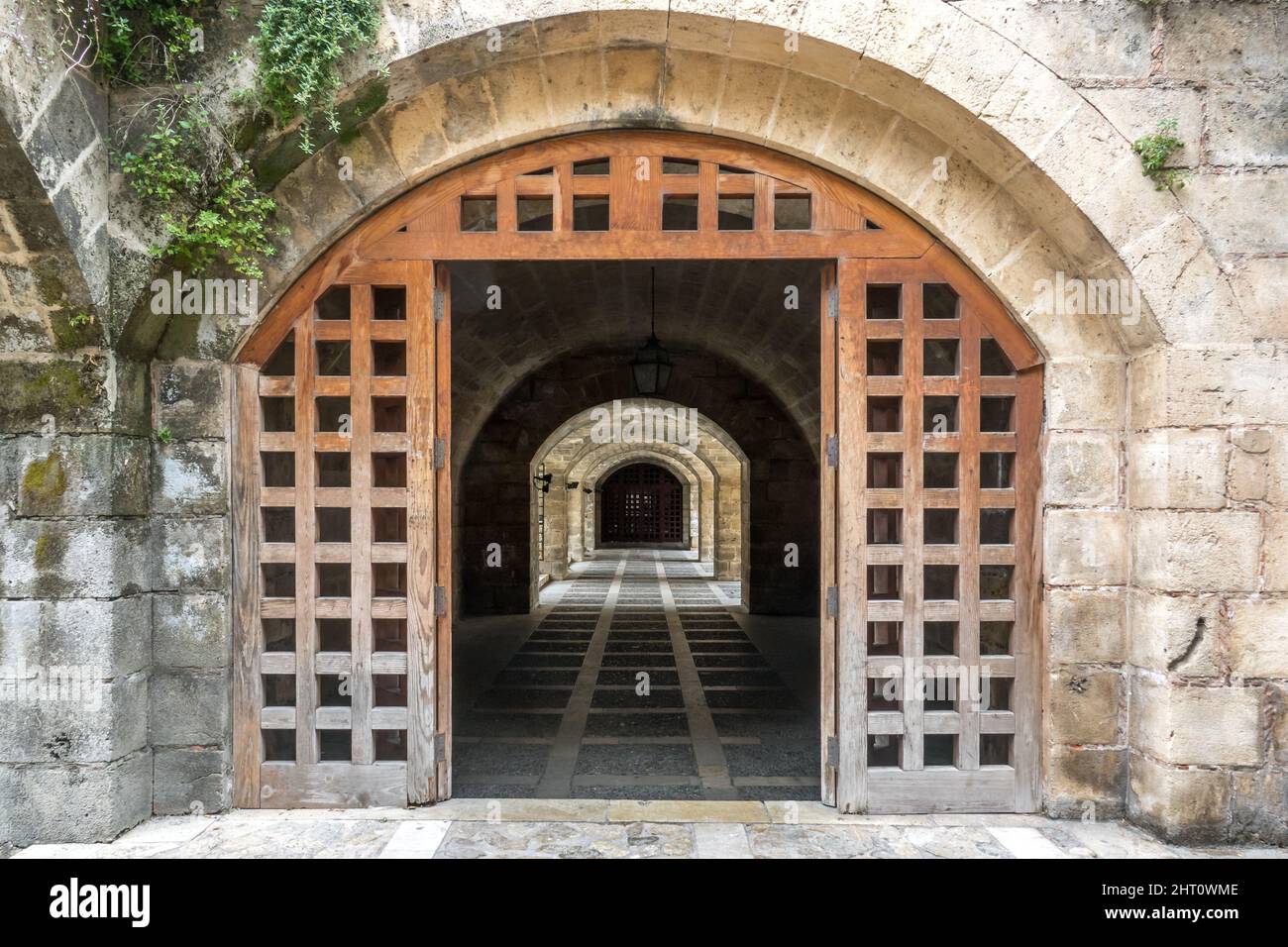 Entrance of a tunnel door corridor with bars at the end light at the ...