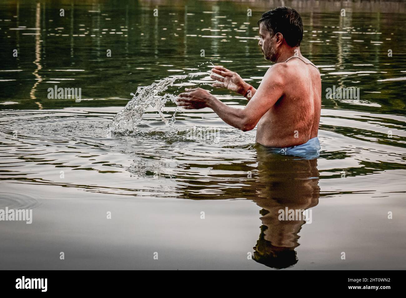Local brahmin taking a bath in the holy water of Devi Kere in Mysore ...