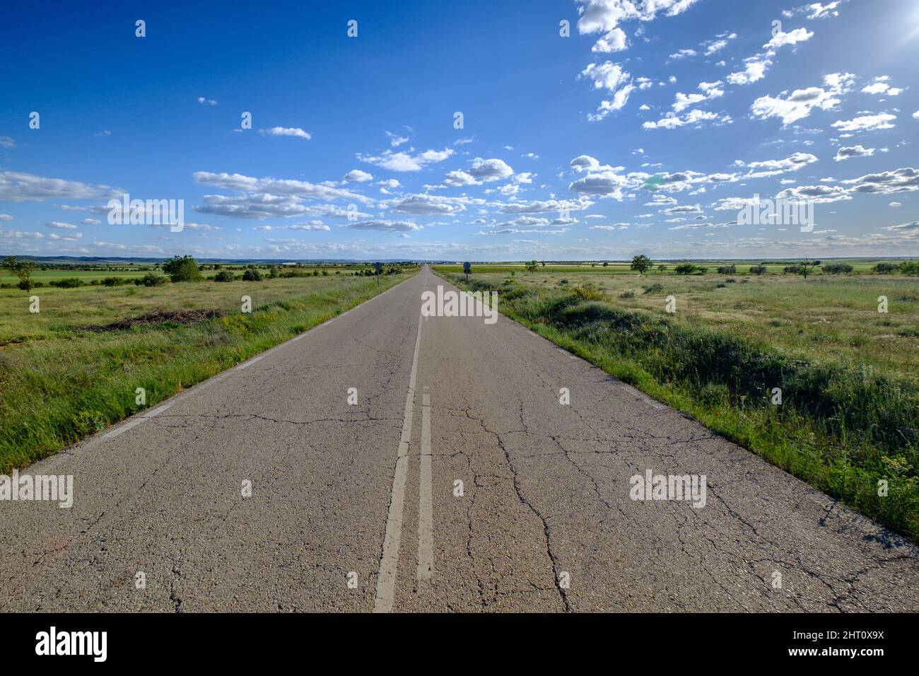 country road empty damaged asphalt in the countryside long straight way ...