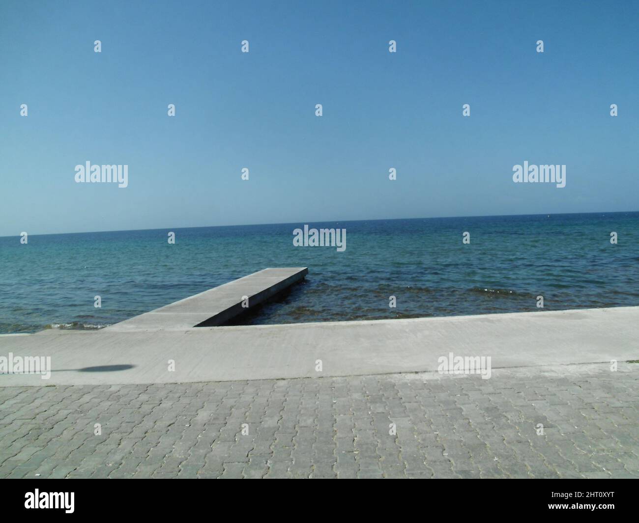Concrete breakwater on the beach at sunrise Stock Photo - Alamy