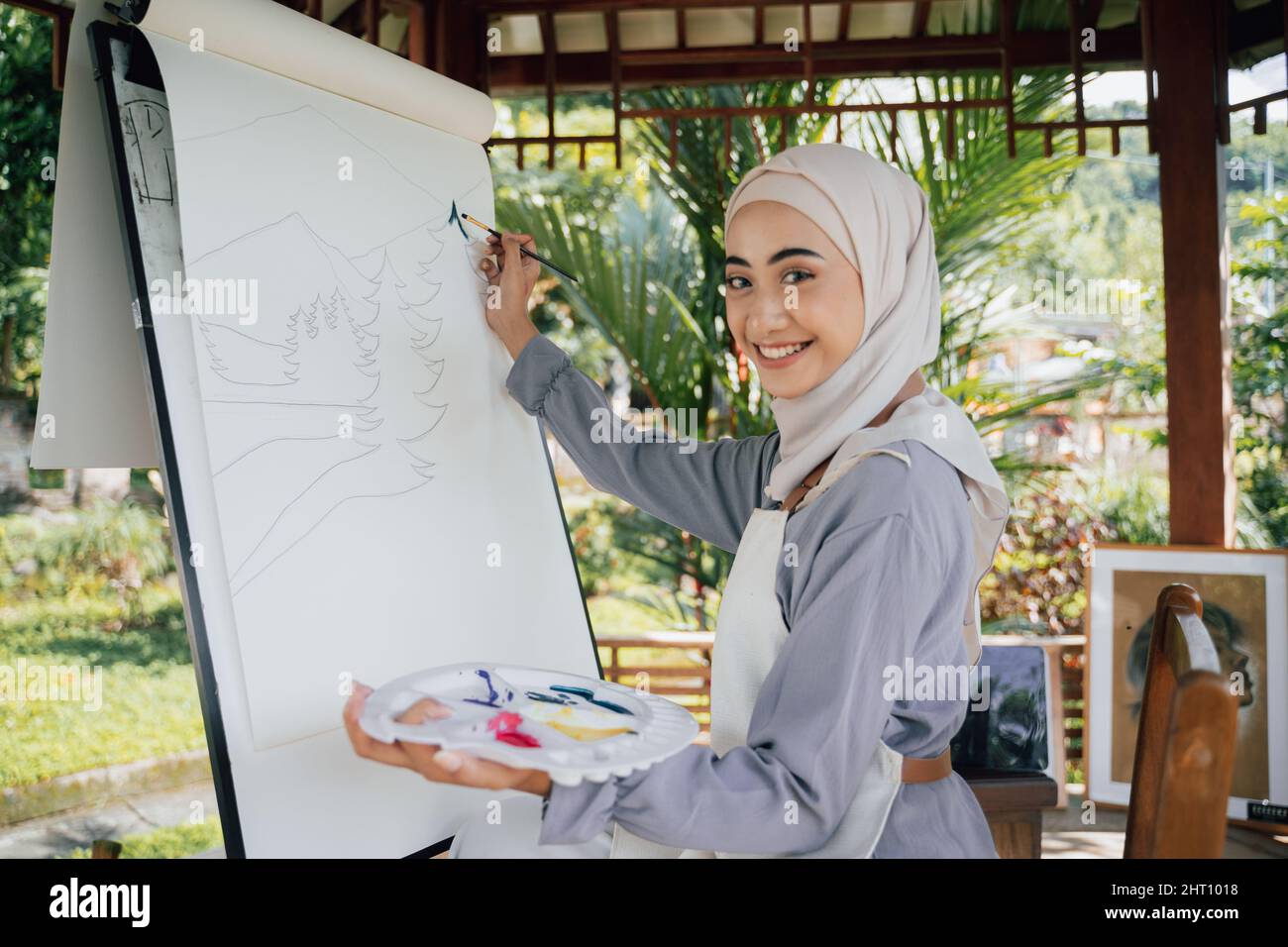 muslim female painter painting on canvas in her workshop Stock Photo ...