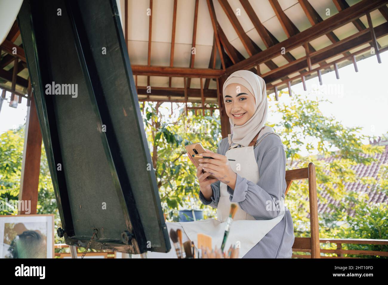 muslim Female artist painting on canvas at home studio Stock Photo - Alamy