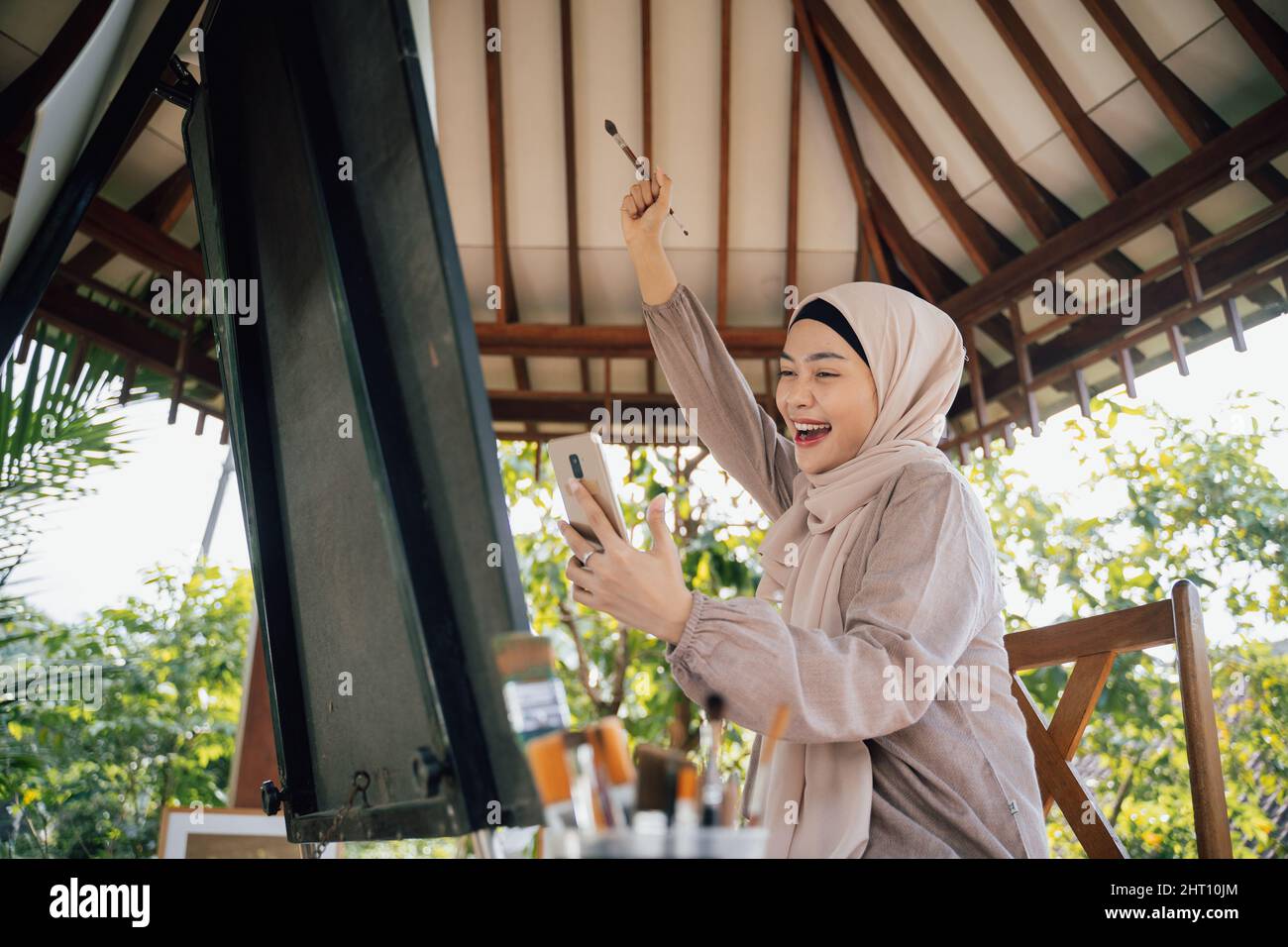 muslim painter is painting in her workshop excitedly Stock Photo - Alamy