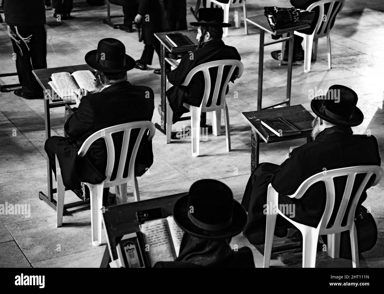 Man sitting on chair behind Black and White Stock Photos & Images - Alamy