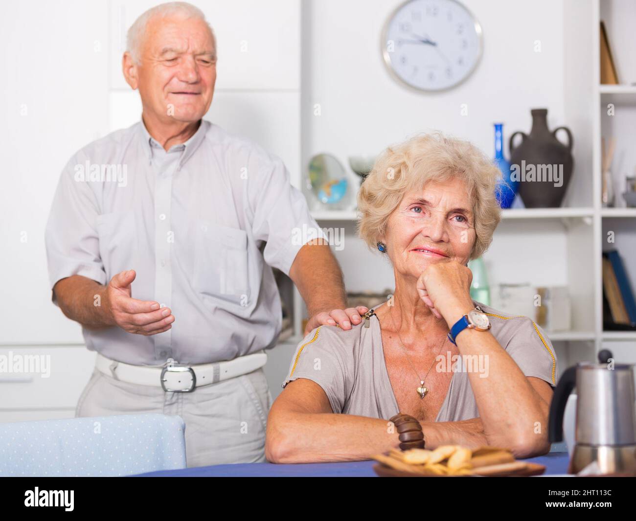 Mature gentleman trying to calm female Stock Photo - Alamy