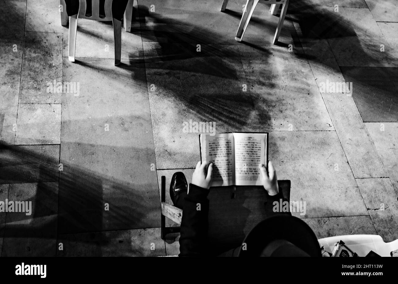 Man sitting on chair behind Black and White Stock Photos & Images - Alamy