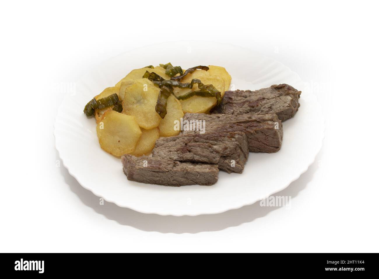 Closeup shot of French fries with roast beef cut into strips isolated ...