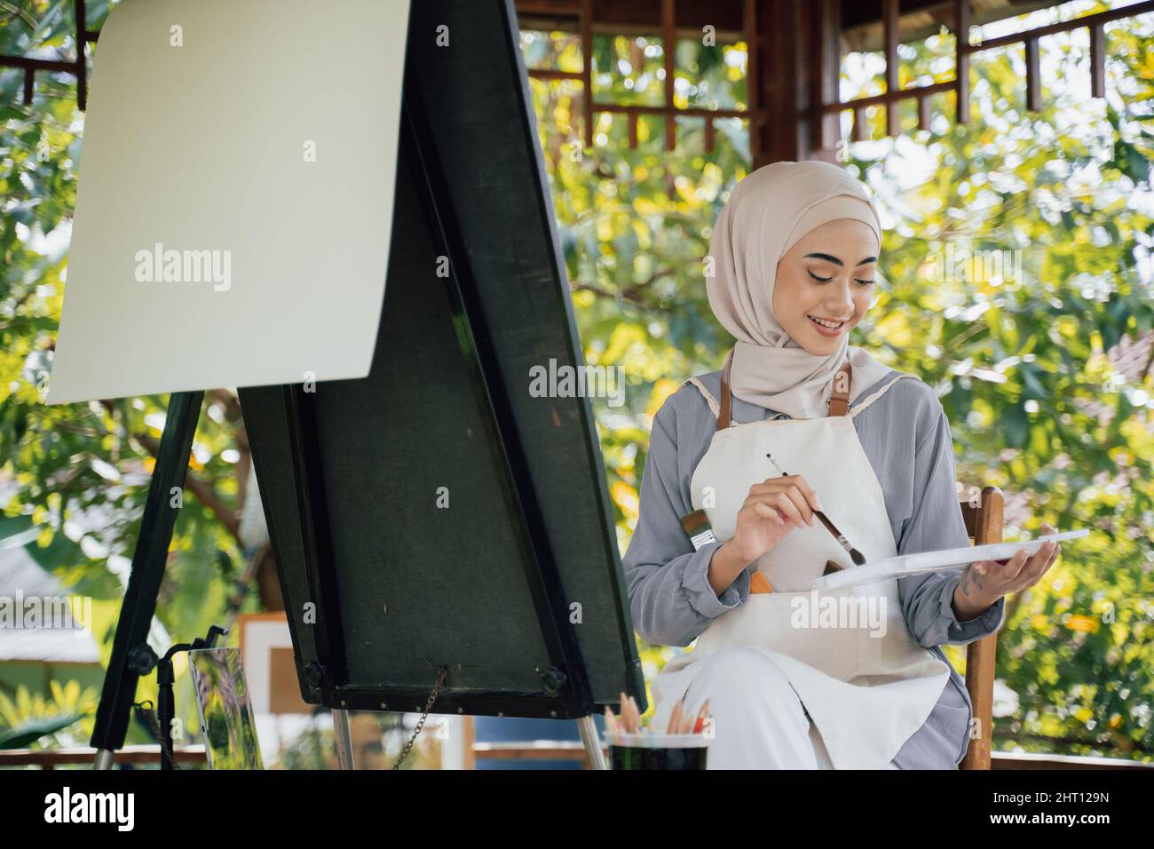 muslim painter is painting in her workshop excitedly Stock Photo - Alamy