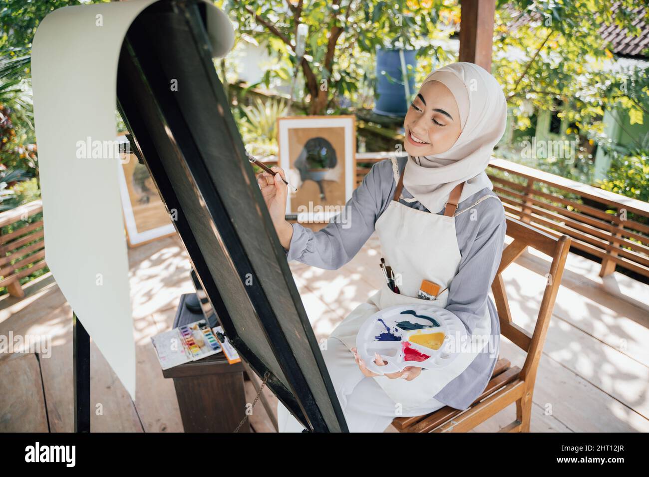 muslim Female artist painting on canvas at home studio Stock Photo - Alamy