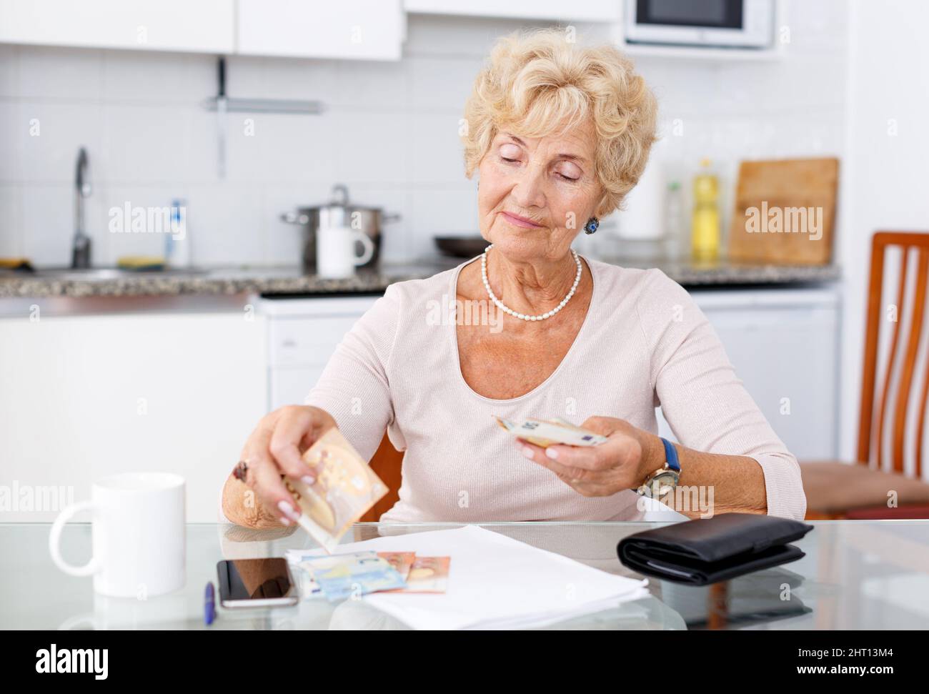 Old woman counting money sitting hi-res stock photography and images ...