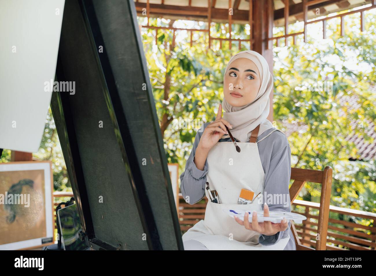 muslim artist painter thinking about what to paint Stock Photo - Alamy
