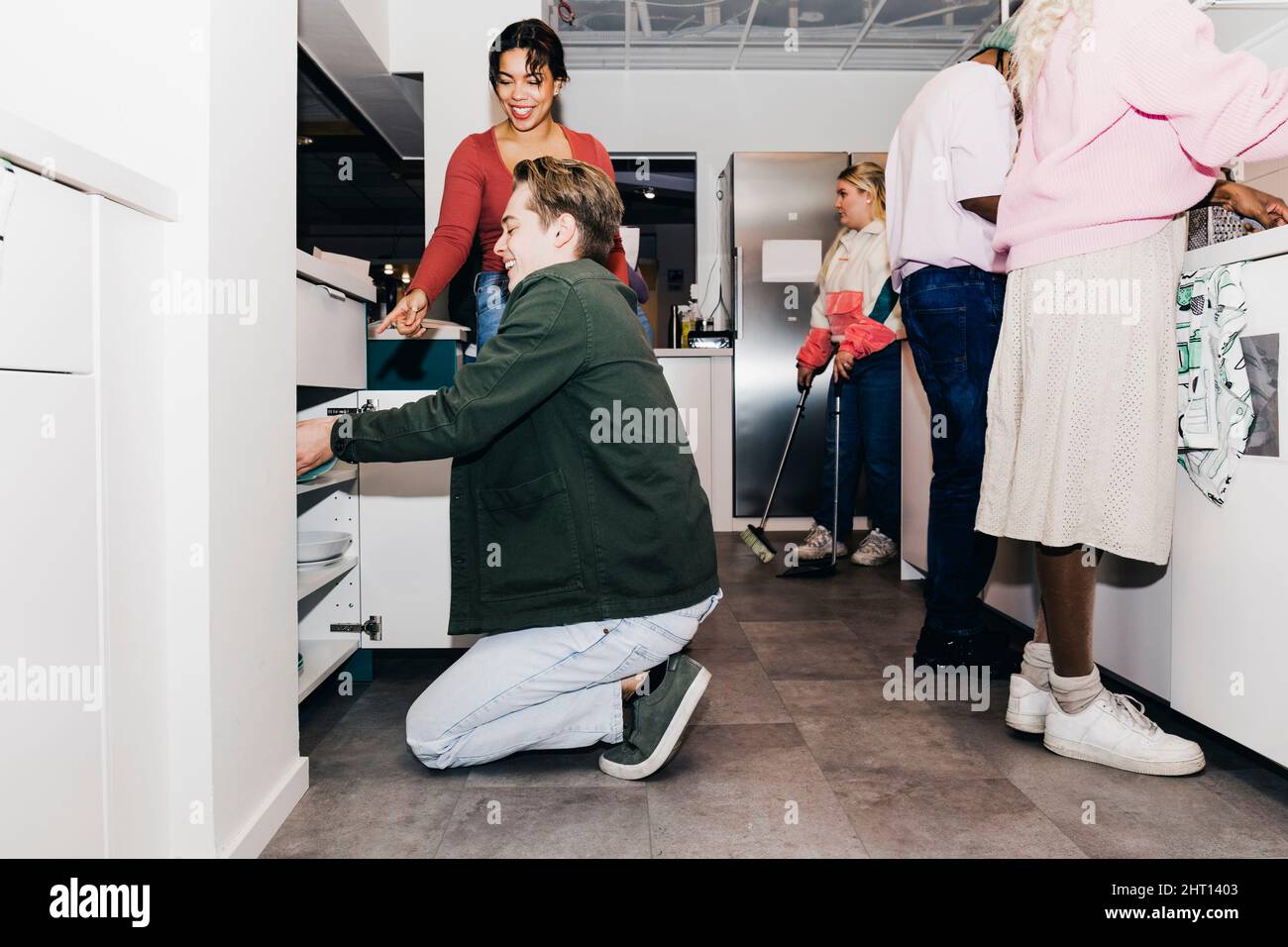 Multiracial male and female students doing chores in dorm Stock Photo ...