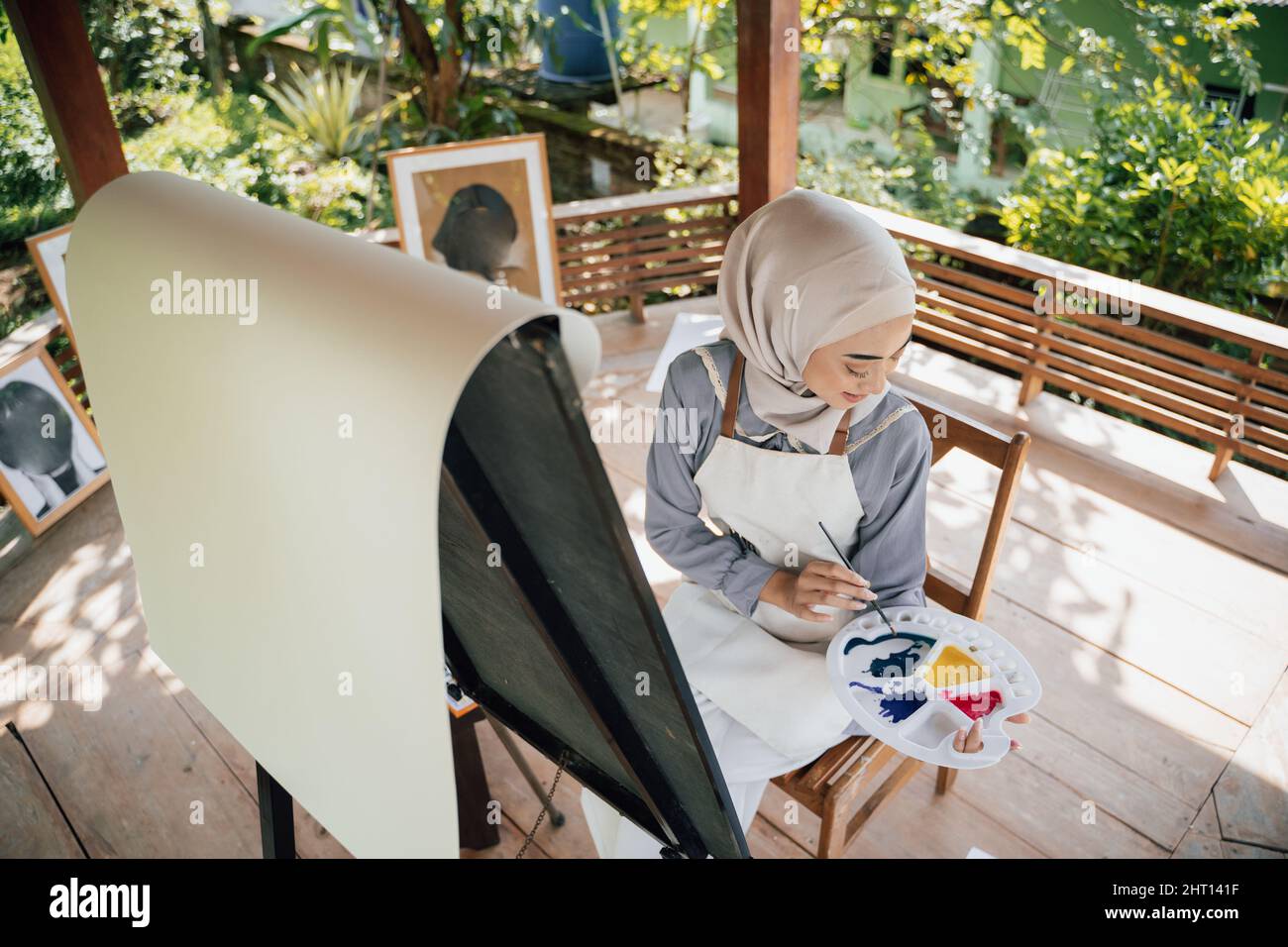 muslim Female artist painting on canvas at home studio Stock Photo - Alamy