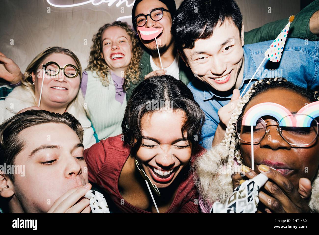 Carefree multiracial roommates with props enjoying in college dorm ...