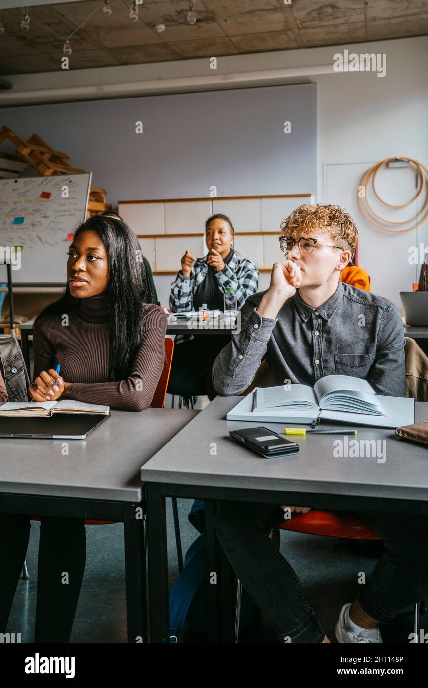 University students sitting at desk in classroom Stock Photo - Alamy