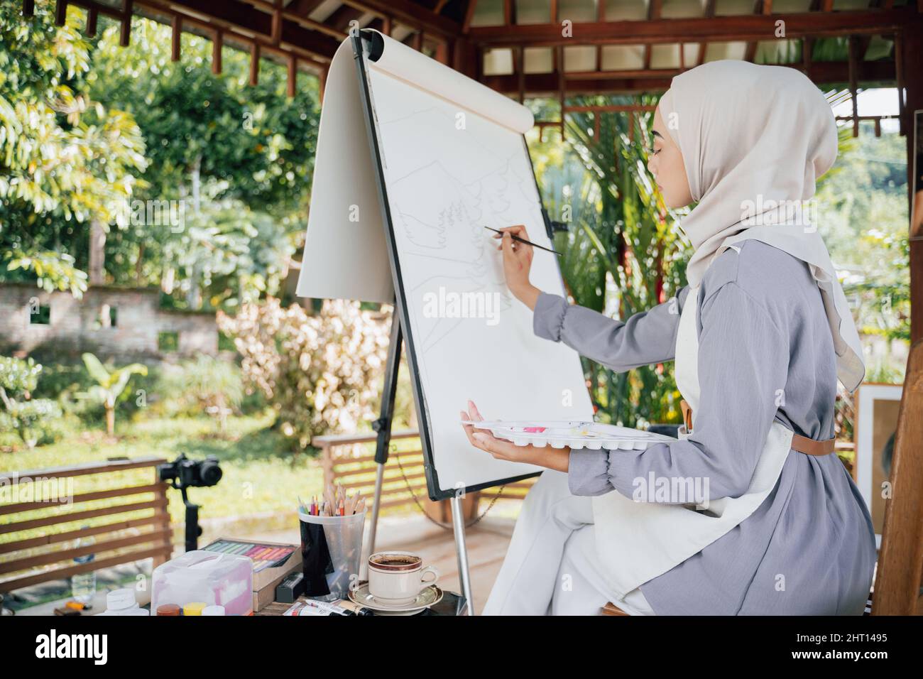 muslim Female artist painting on canvas at home studio Stock Photo - Alamy
