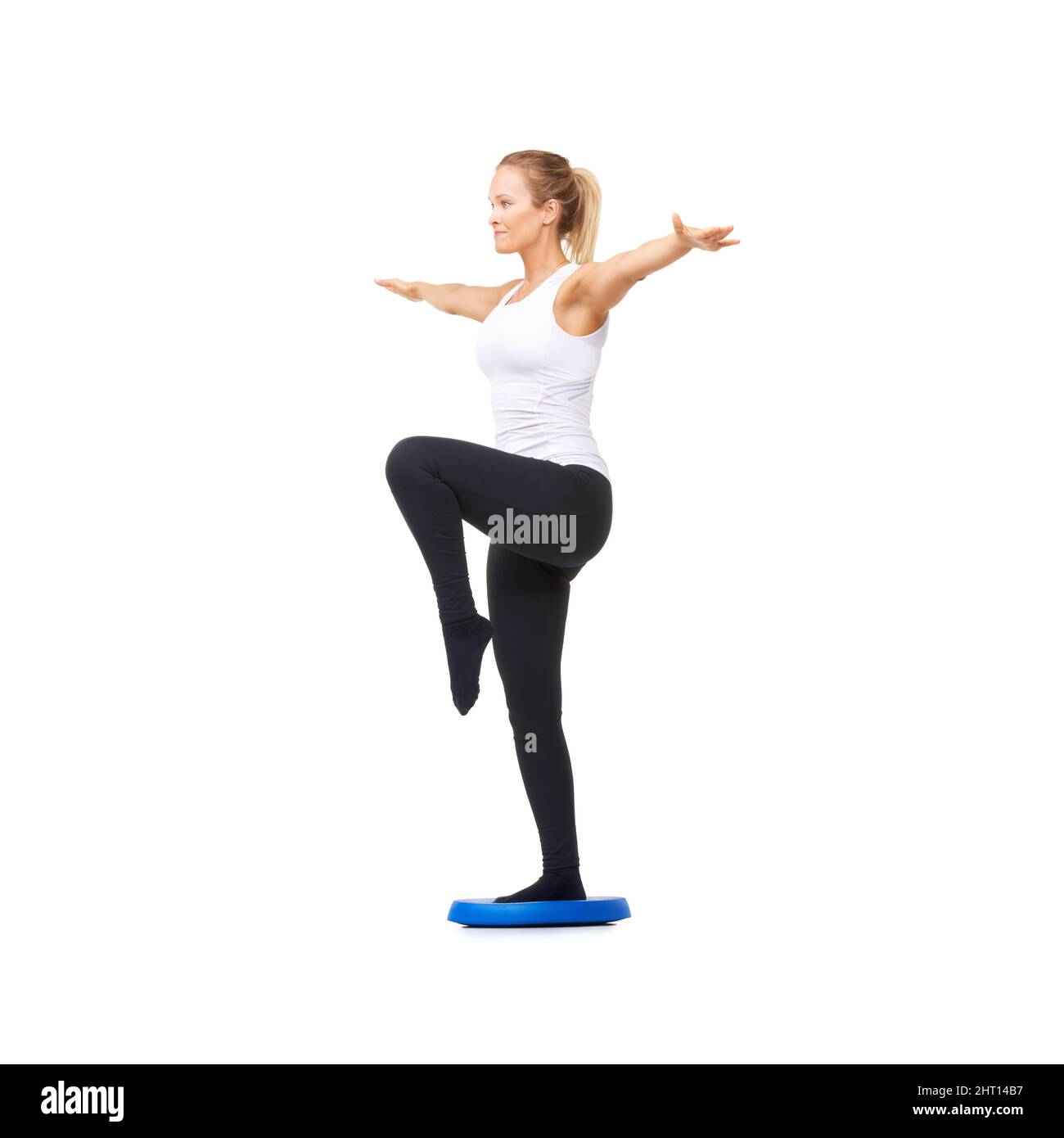 Crane pose. Full length studio shot of a beautiful young woman doing ...