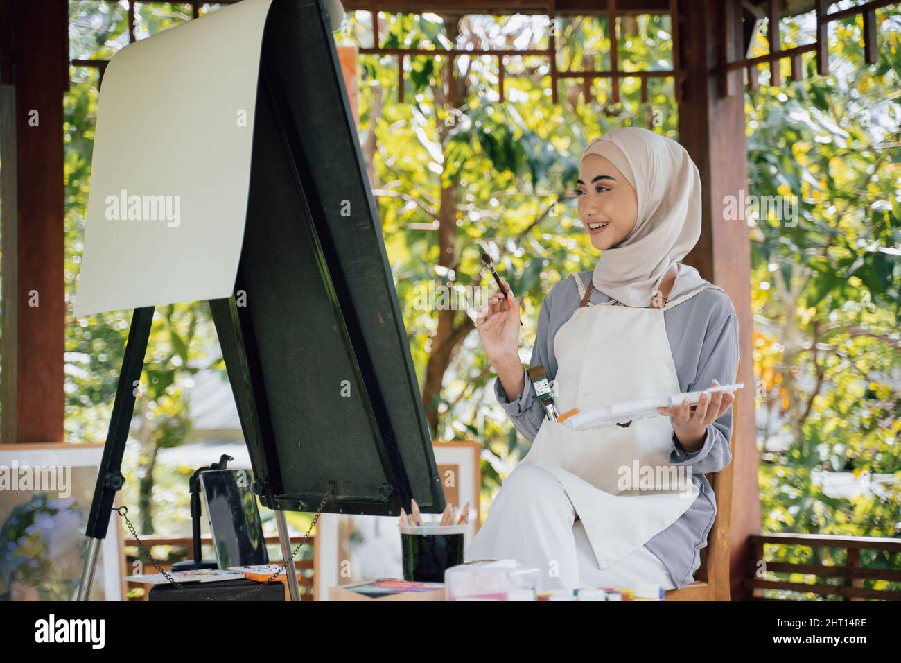 muslim Female artist painting on canvas at home studio Stock Photo - Alamy