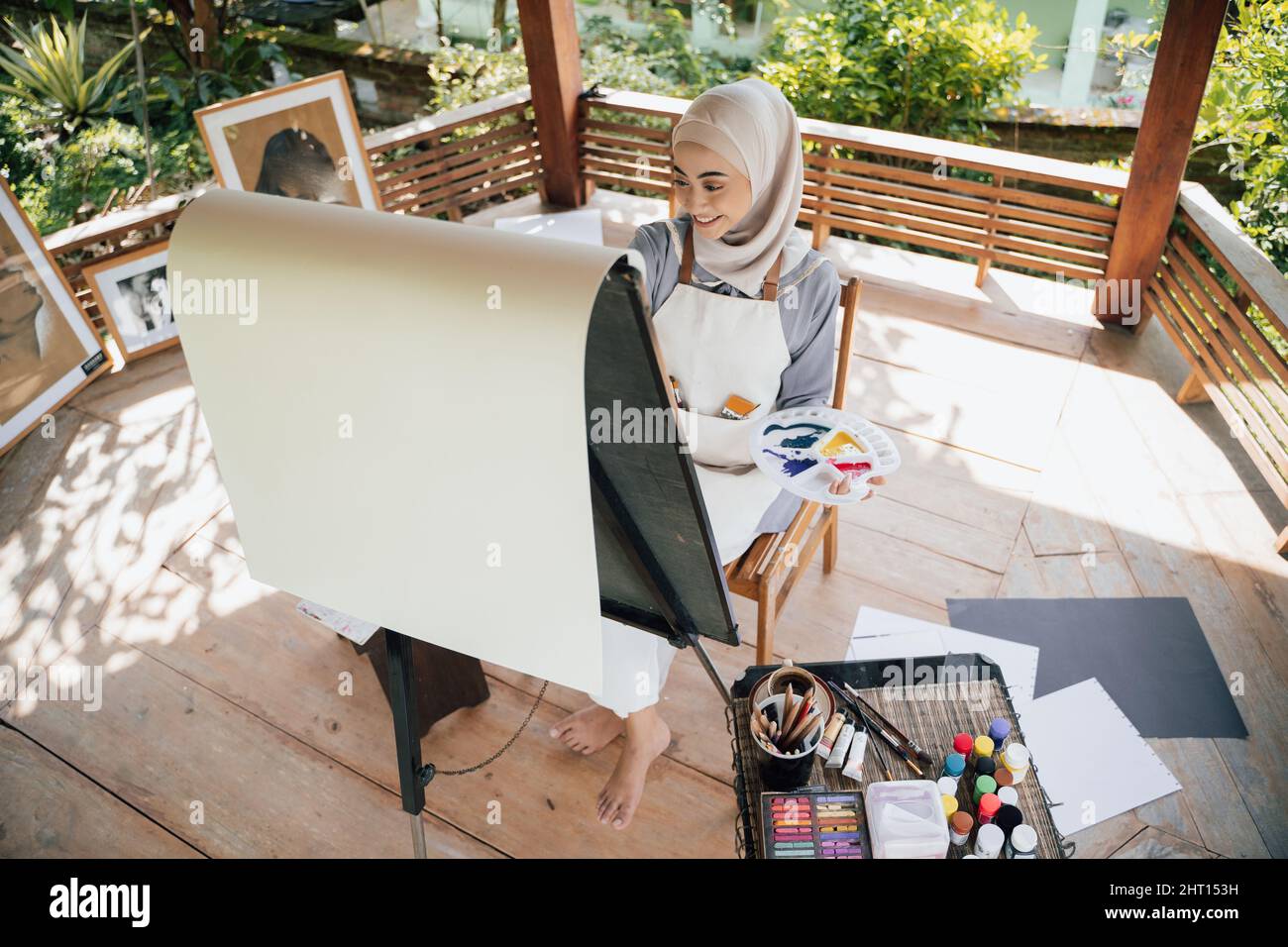 muslim Female artist painting on canvas at home studio Stock Photo - Alamy