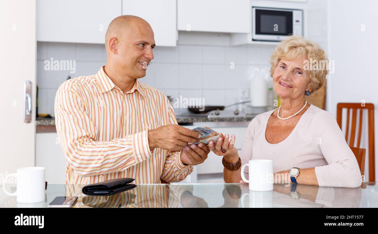 Woman giving money son hi-res stock photography and images - Alamy
