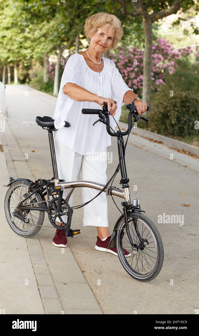 Elderly woman going to biking Stock Photo - Alamy