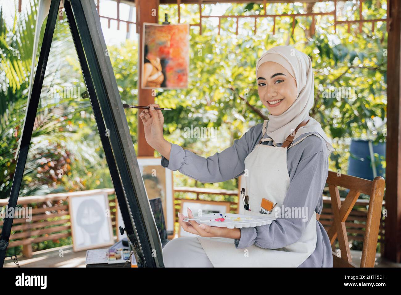 muslim female painter painting on canvas in her workshop Stock Photo ...