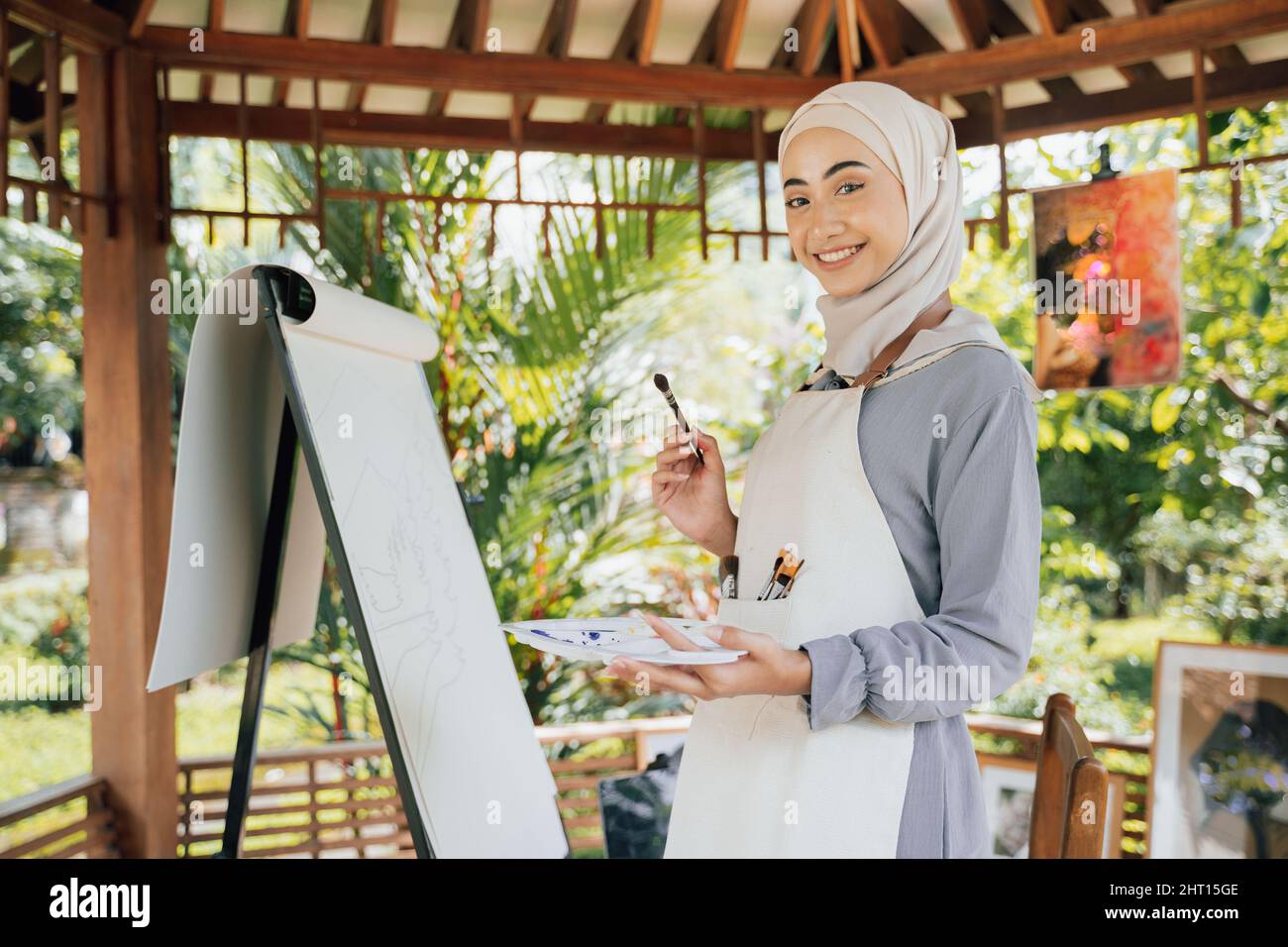 muslim female painter painting on canvas in her workshop Stock Photo ...