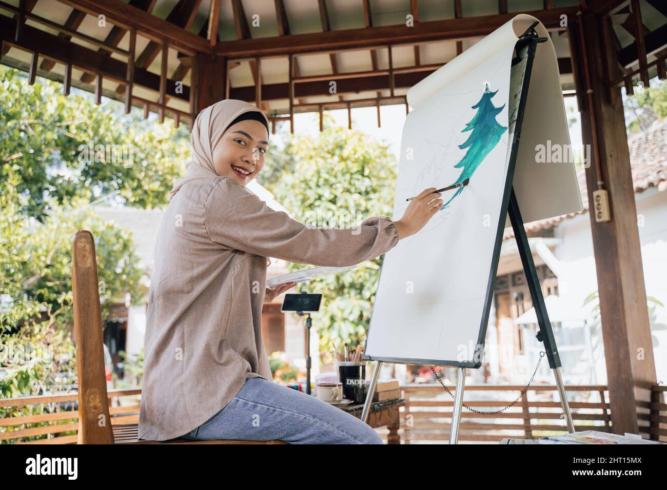muslim Female artist painting on canvas at home studio Stock Photo - Alamy