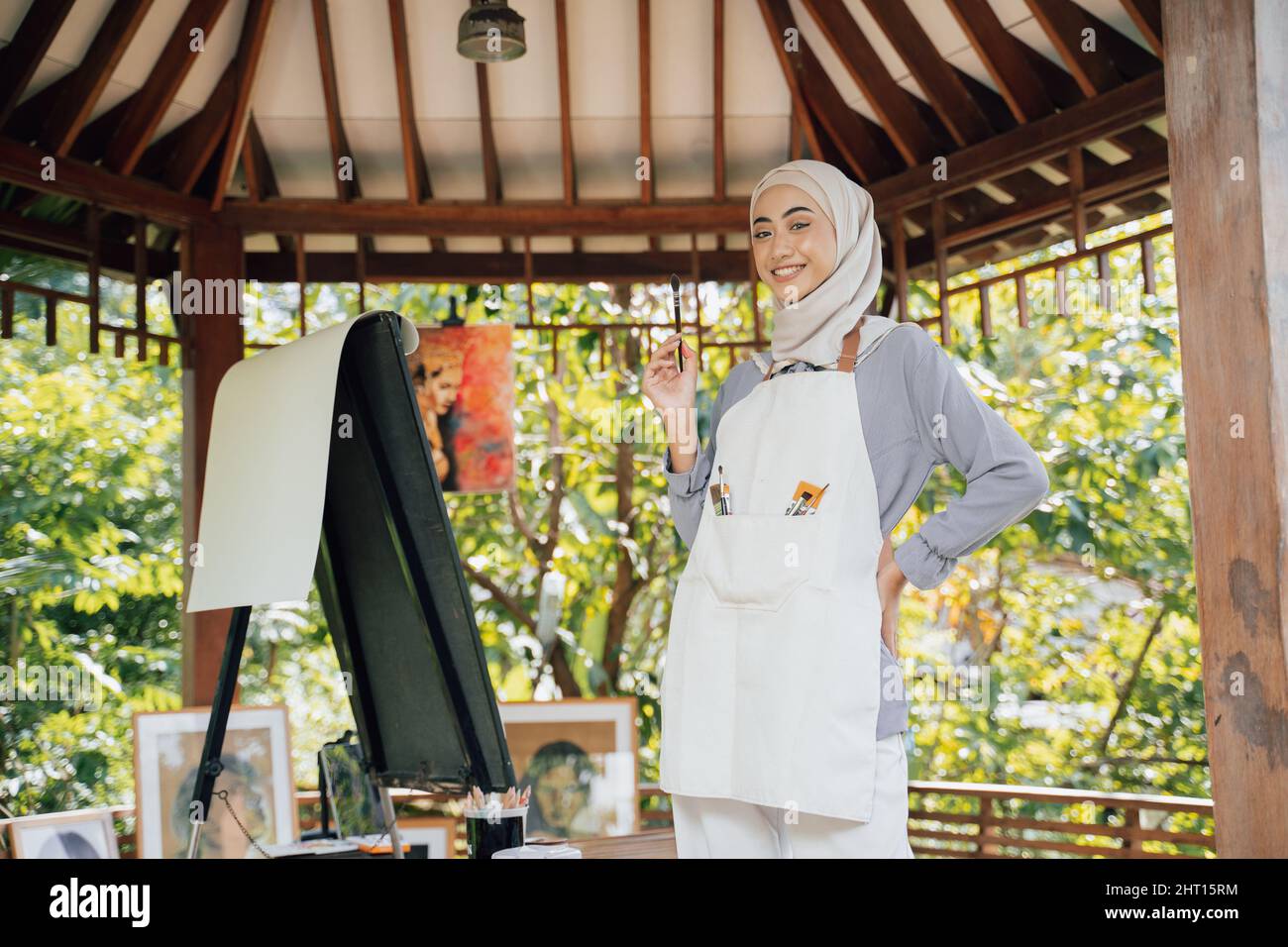 muslim Female artist painting on canvas at home studio Stock Photo - Alamy
