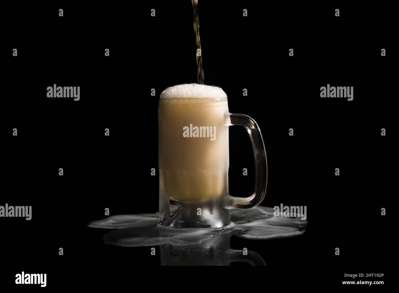 Refreshing, cold and frothy beer on black background Stock Photo - Alamy