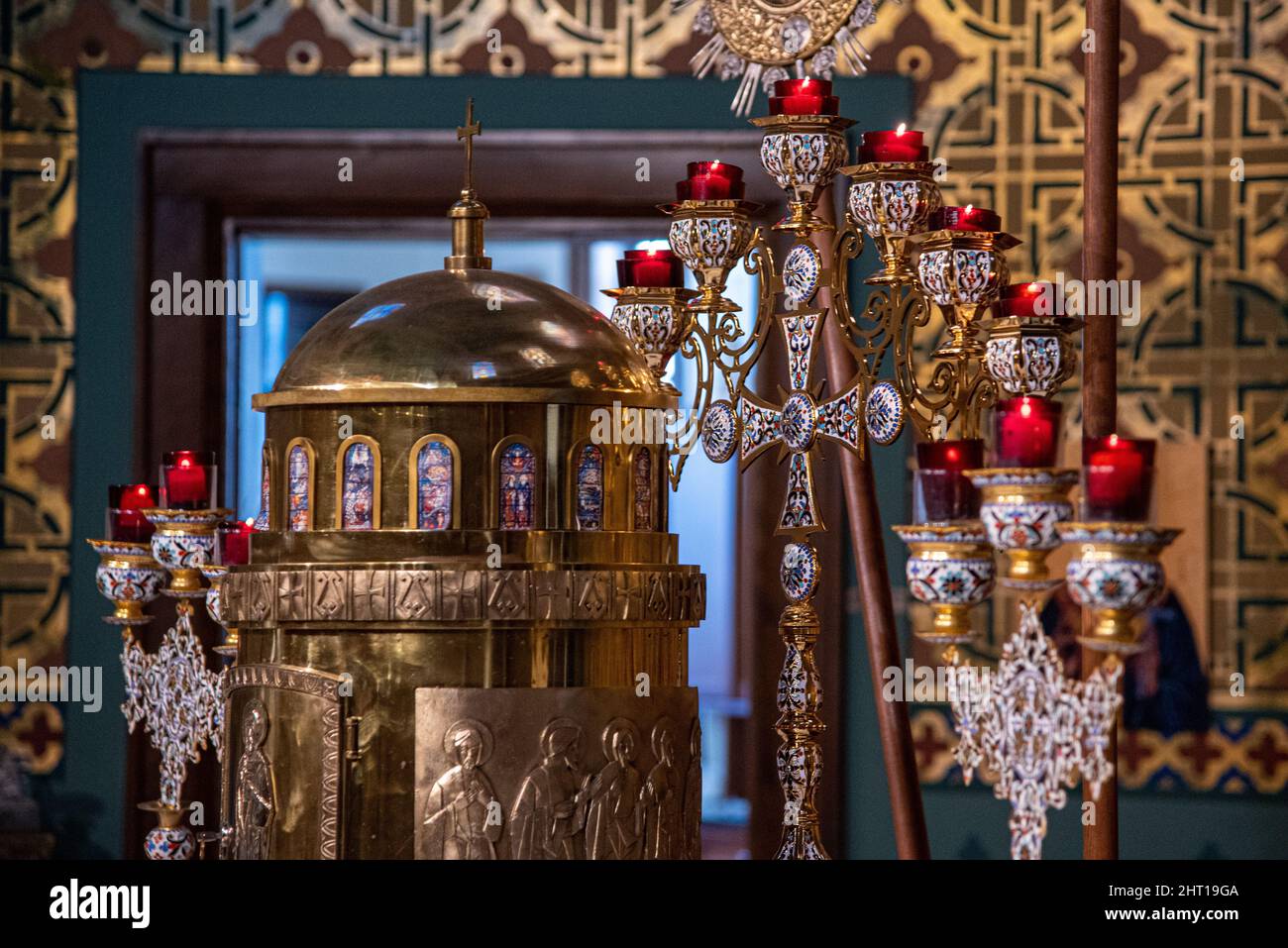 Closeup of decorated red Sanctuary lamps with candles in the church ...