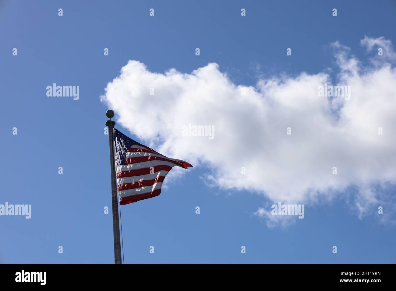 Waving stars and stripes flag of the United States of America against ...