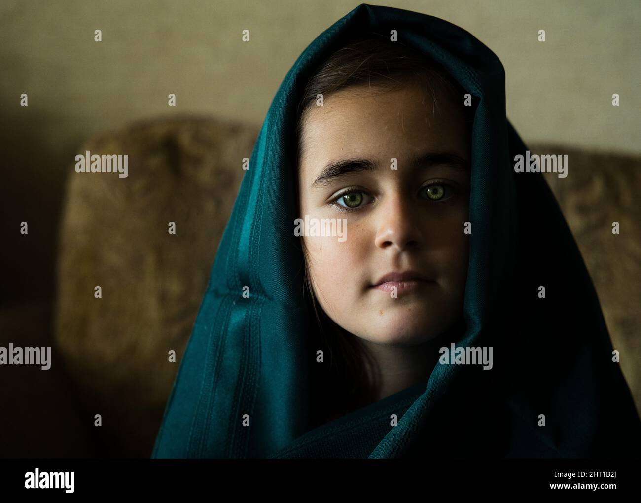Portrait of a multi-racial beautiful female child with green eyes and a turquoise veil Stock ...