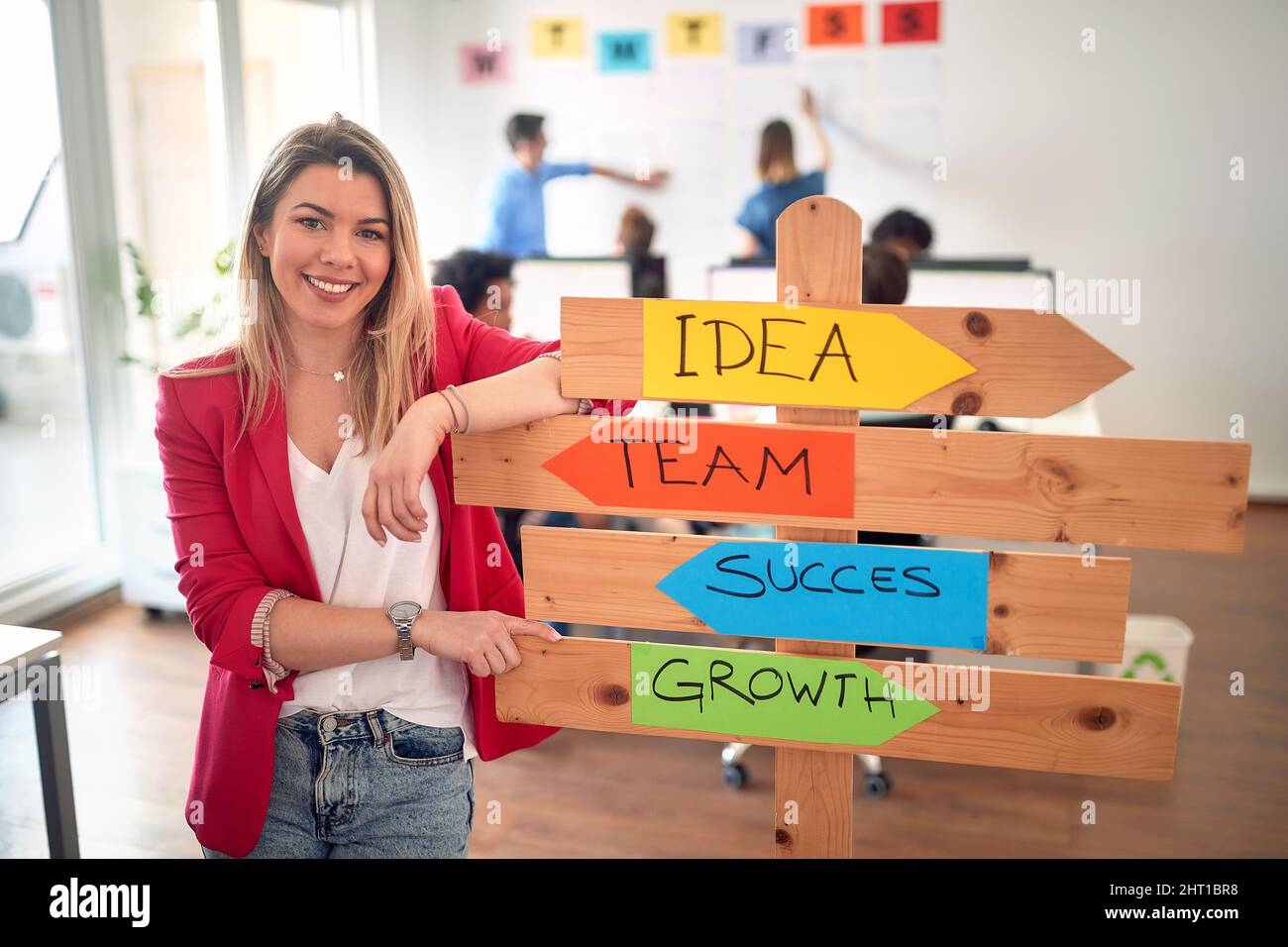 A young beautiful female office worker is promoting company slogans ...