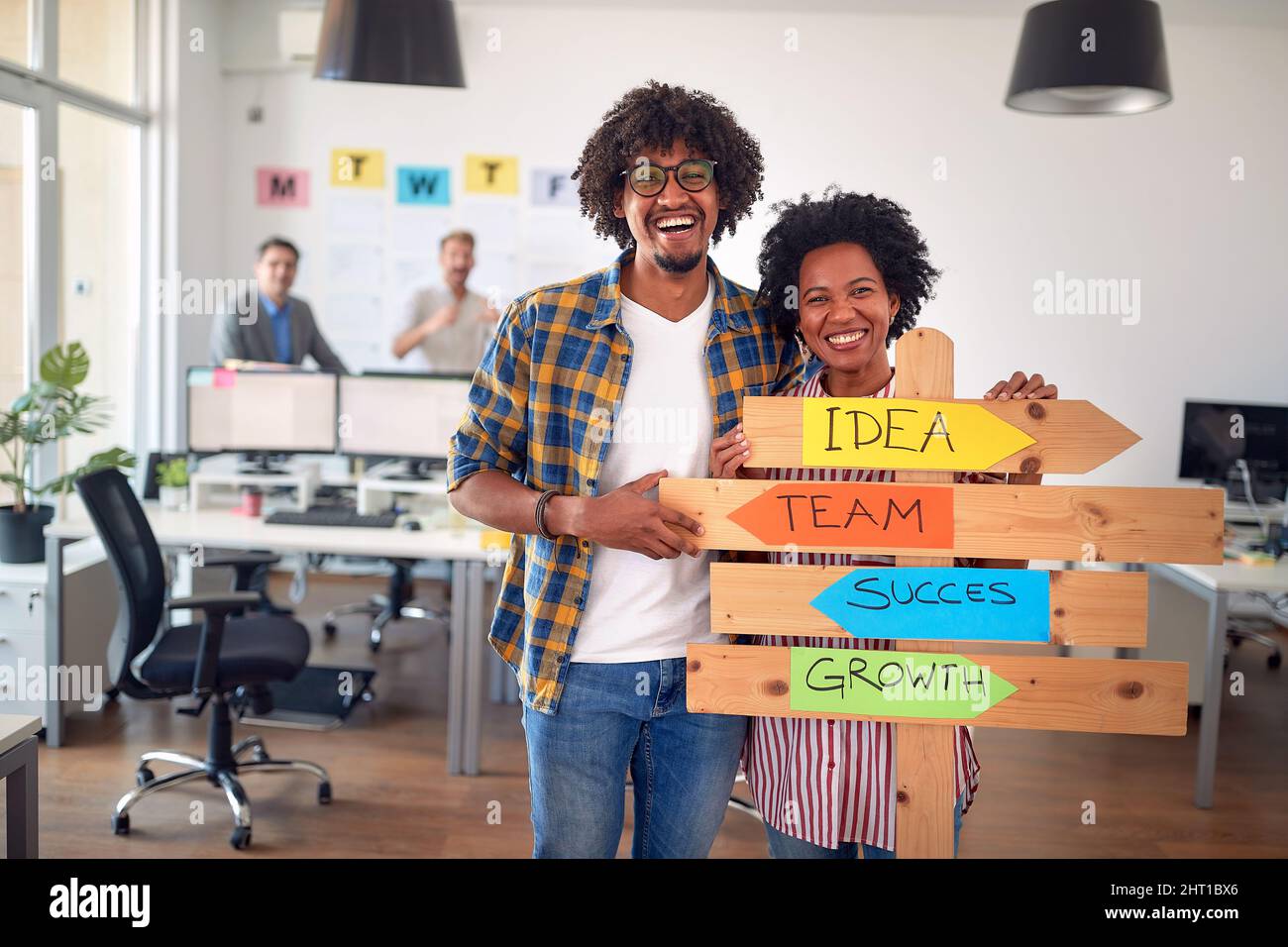 Young cheerful colleagues are posing for a photo and promoting company ...