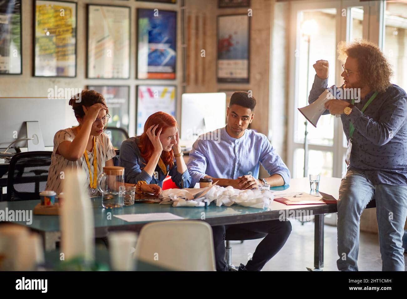 Group of work colleagues having competition together at the office ...