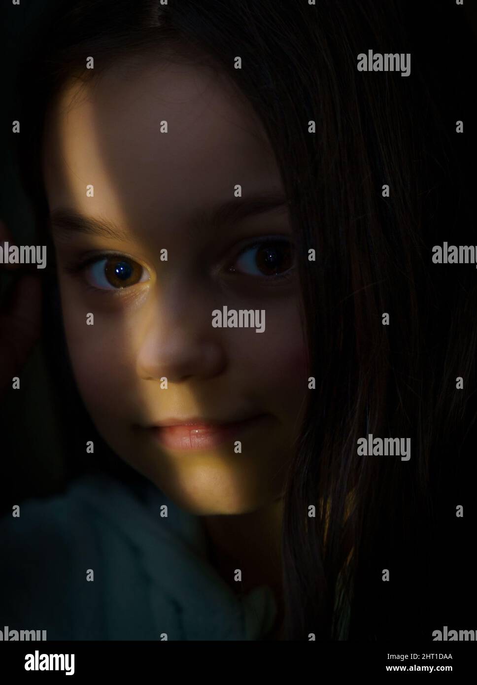 Portrait of a young Caucasian girl in a dark place Stock Photo - Alamy