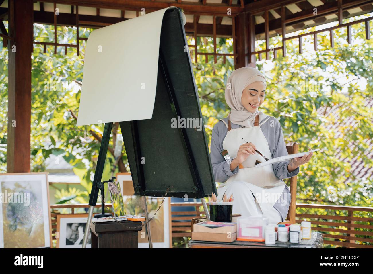 muslim Female artist painting on canvas at home studio Stock Photo - Alamy