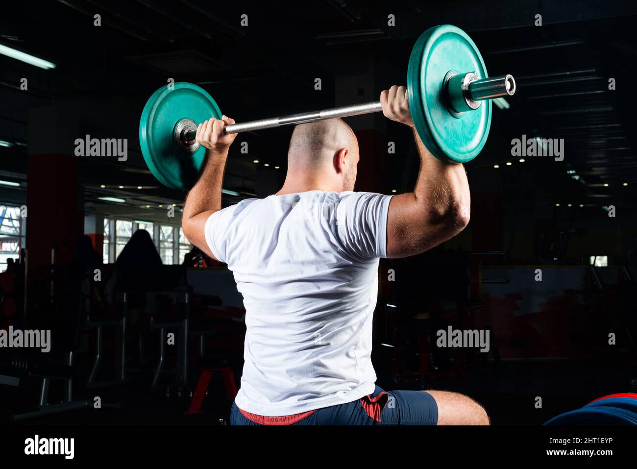Male athlete lifts the barbell Stock Photo - Alamy