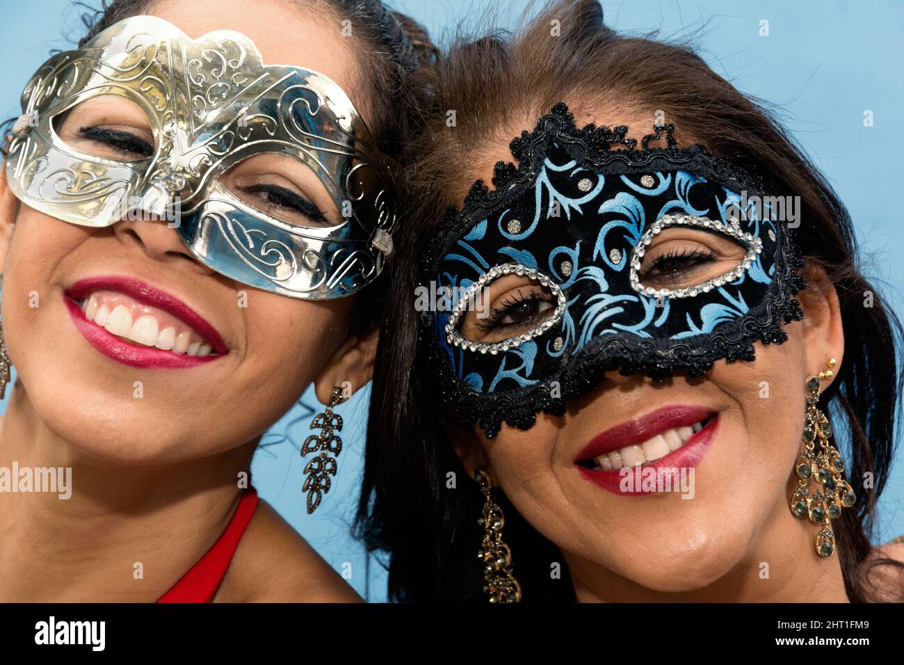 Close-up of face of two women wearing Venice Carnival mask against ...