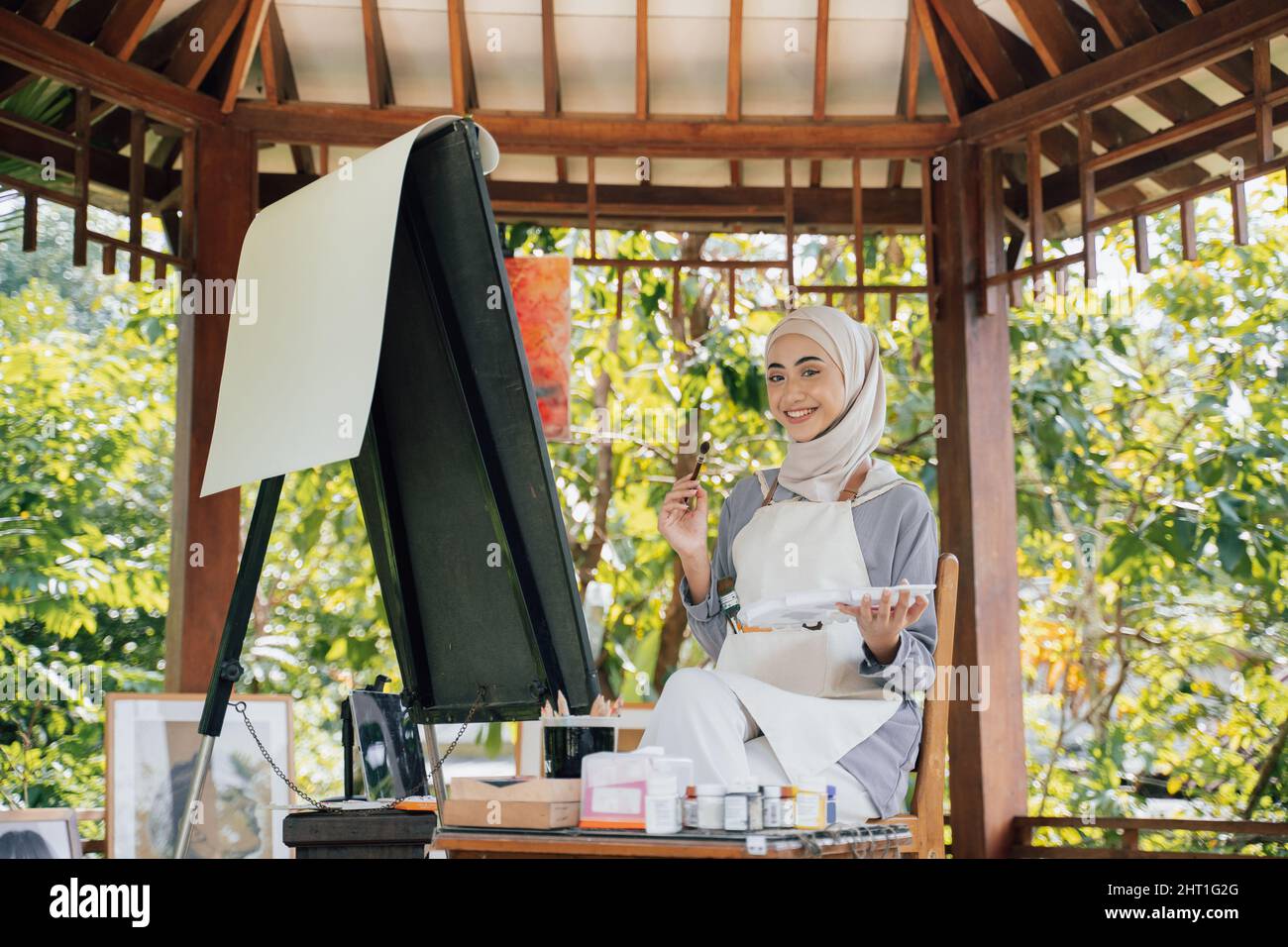muslim female painter painting on canvas in her workshop Stock Photo ...