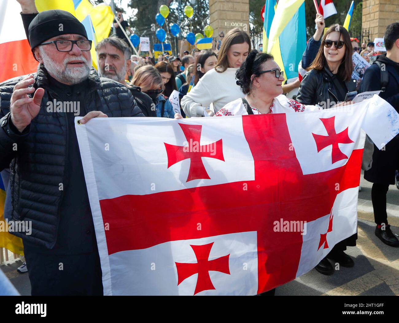 Protesters hold placards and flags during the demonstration. People ...