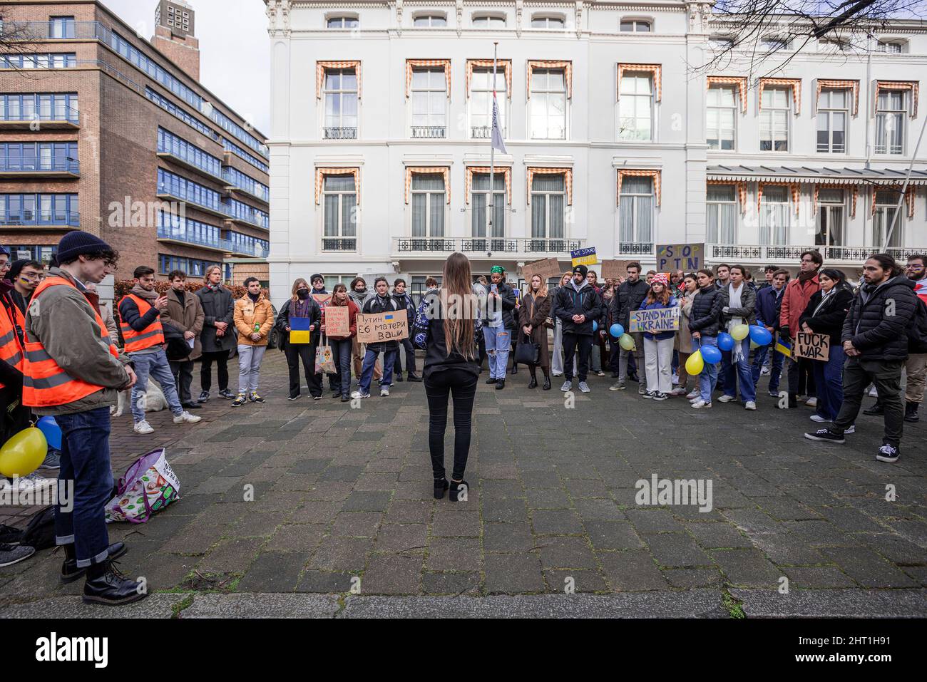 A woman speaks to protesters holding placards during the demonstration ...