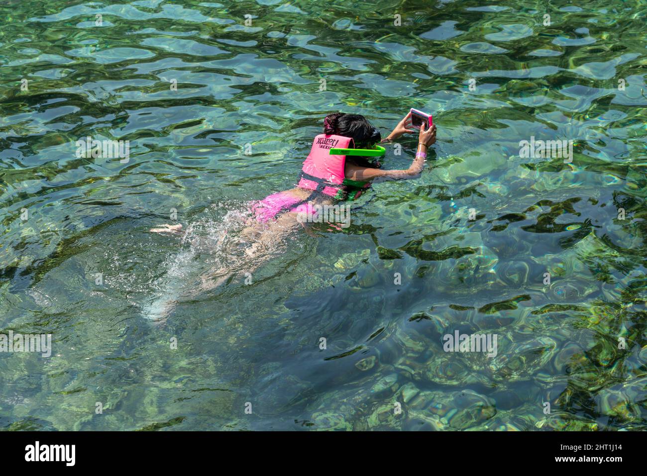Girl wearing life jacket snorkeling in ocean clear water Stock Photo ...