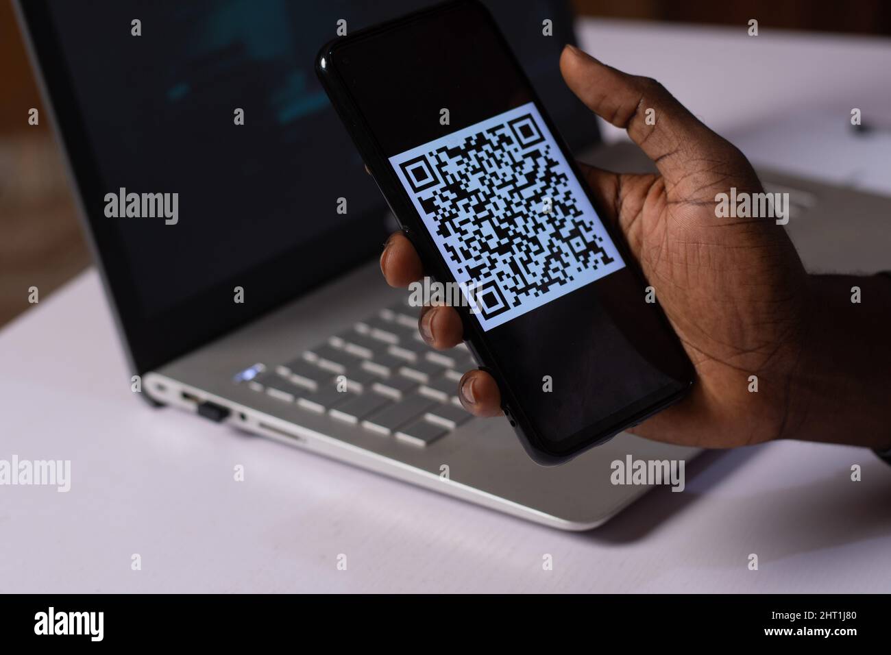 Nigerian woman holding a smartphone with a QR code on a display Stock ...