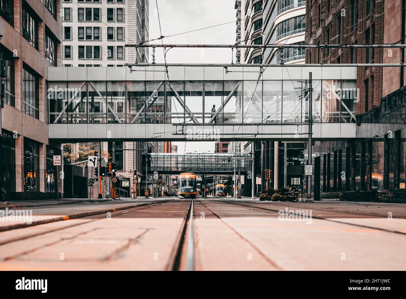 Low angle of a modern-style bridge connecting two buildings above a ...