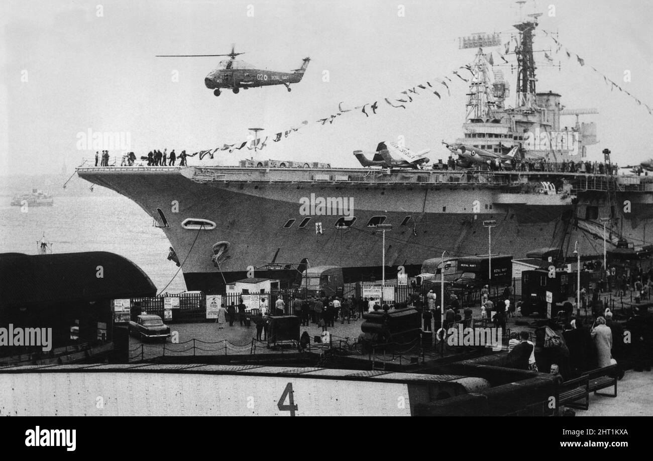A helicopter taking off from the aircraft carrier HMS Centaur, berthed ...